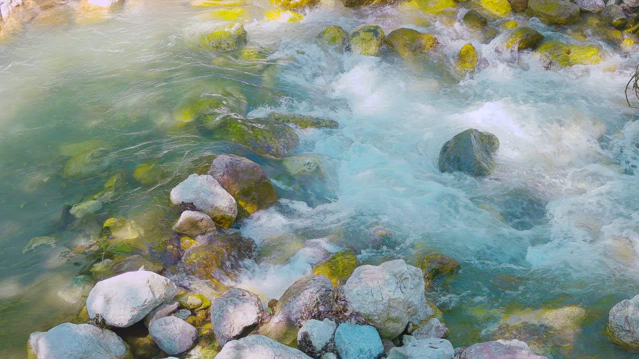 Flowing water over moss covered rocks - Free Stock Video