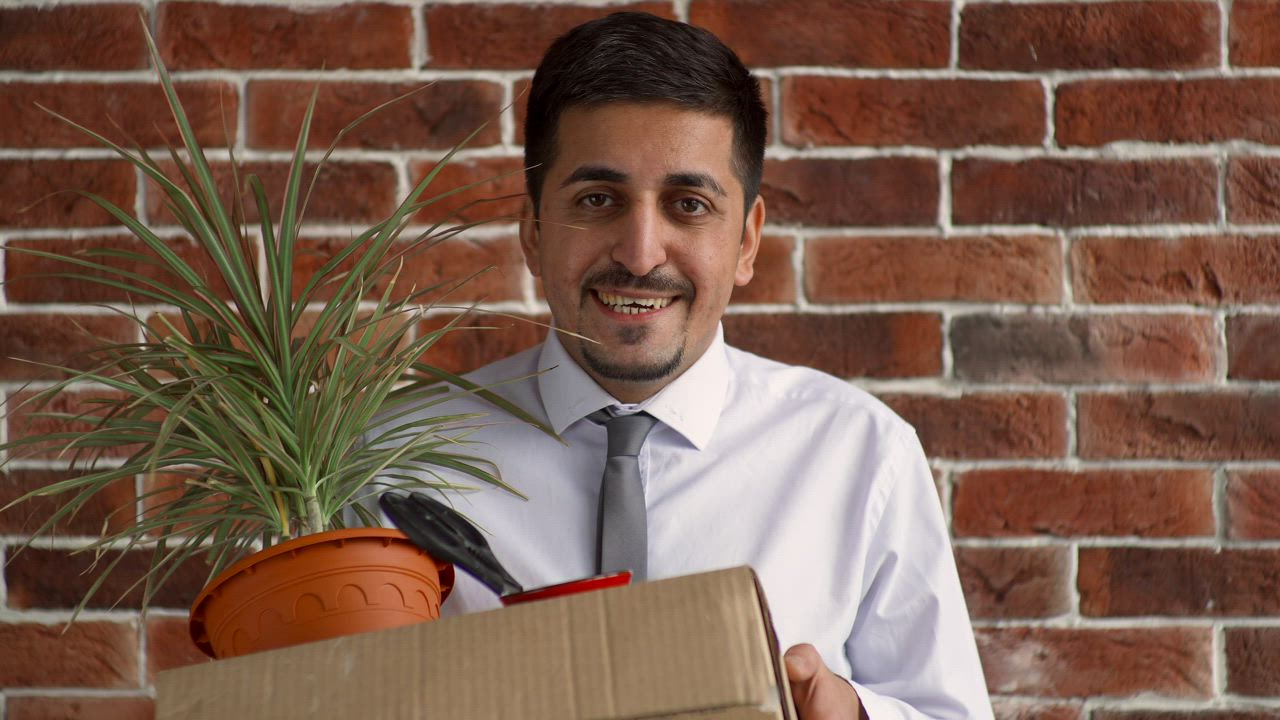 Man having a laugh in the office after being fired - Free Stock Video