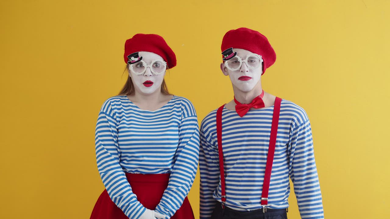 Two mimes having a laugh in costume on a yellow background - Free Stock ...