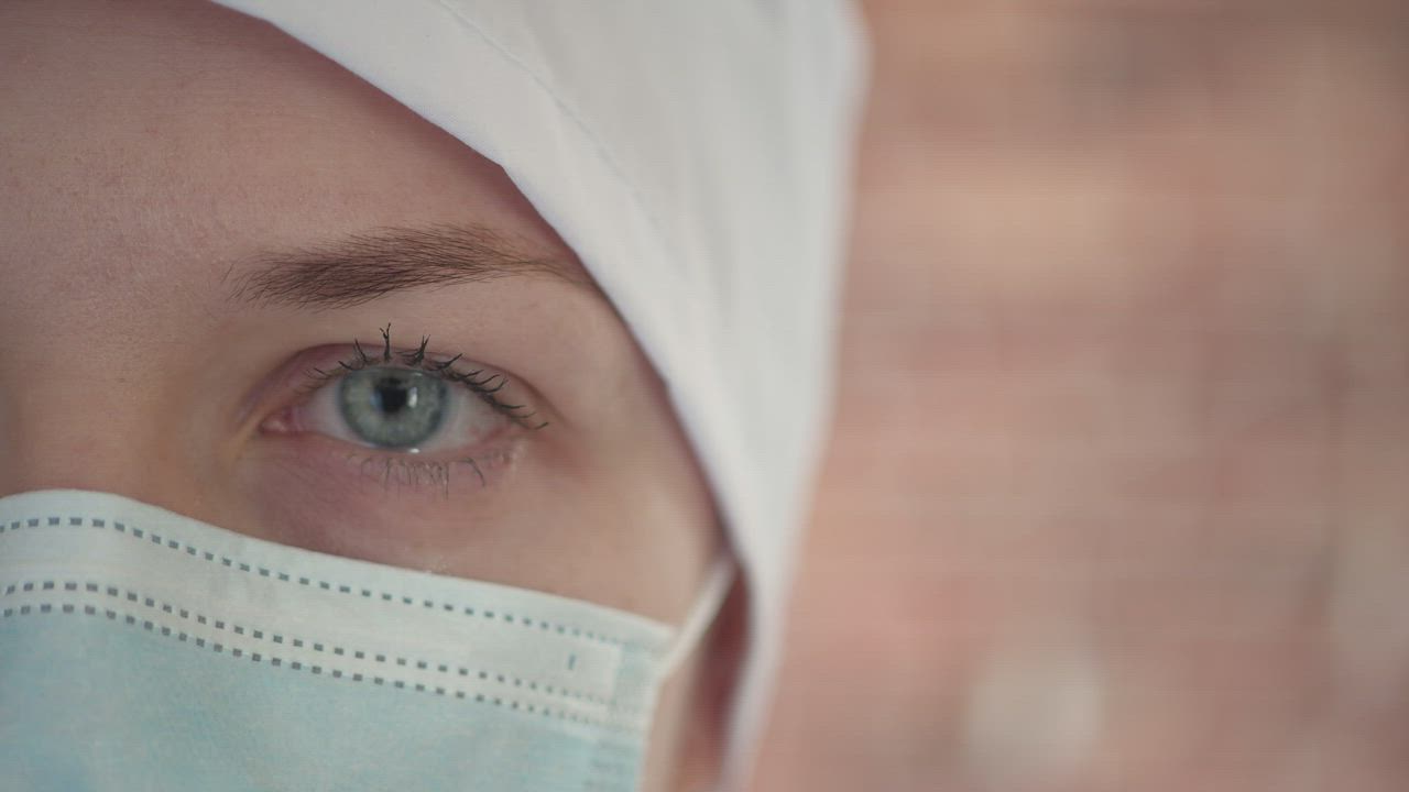 Close up of a struggling nurse in a mask blinking back tears - Free ...