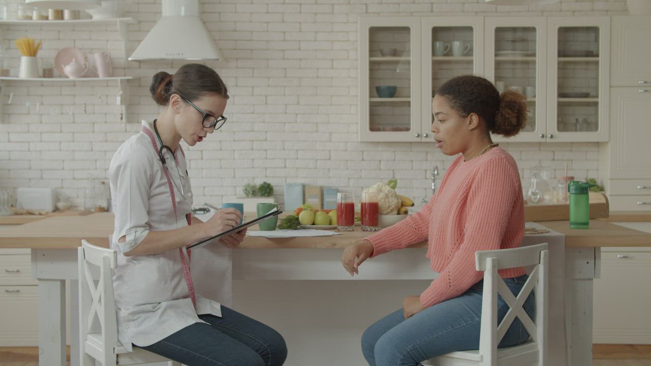 Nutritionist in a kitchen consultation - Free Stock Video