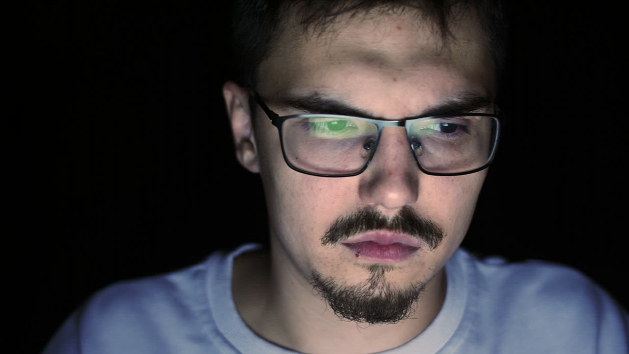 Close up of a man illuminated by a computer screen in the dark - Free ...