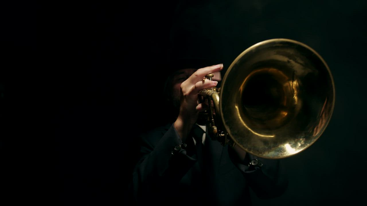Close up of a trumpet being played on a black background - Free Stock Video