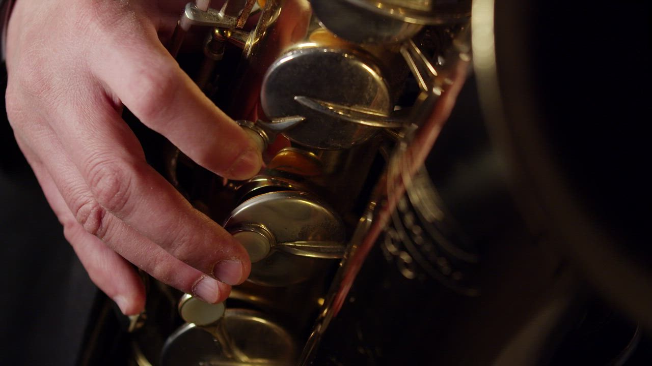 Close up of a musician moving the valves on a saxophone - Free Stock Video
