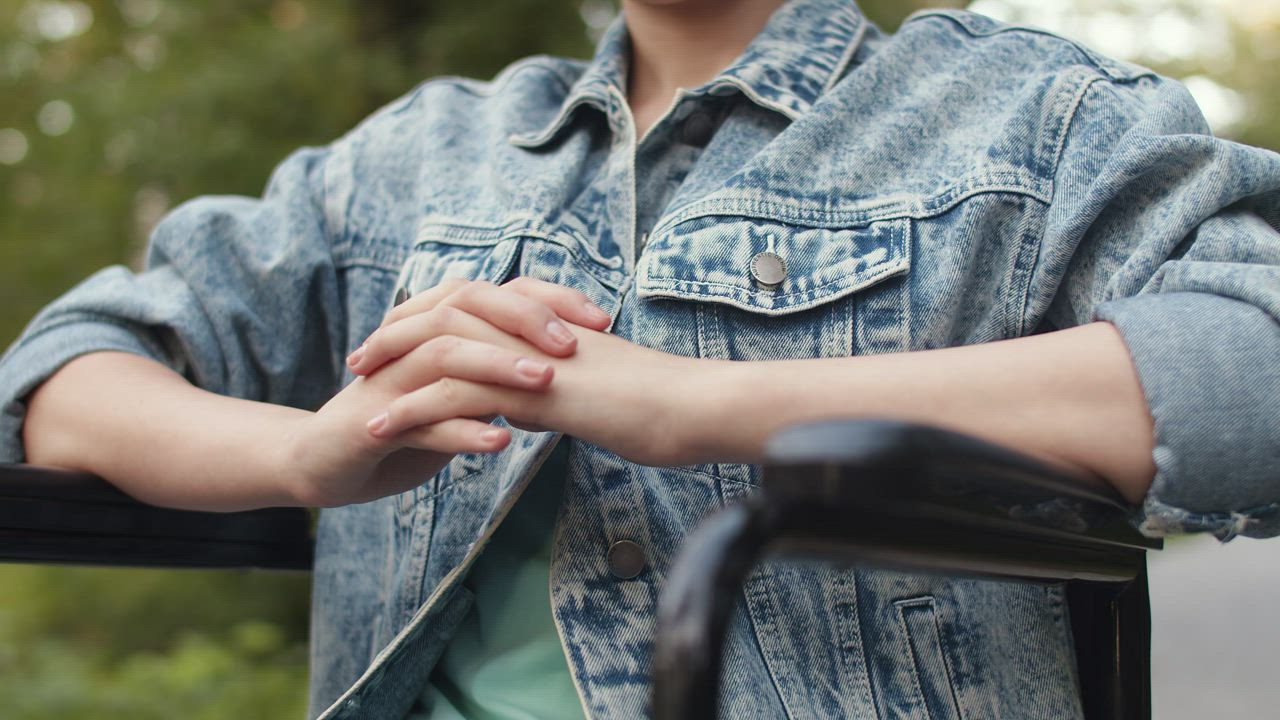 Woman with folded hands resting on the arms of a wheelchair - Free ...