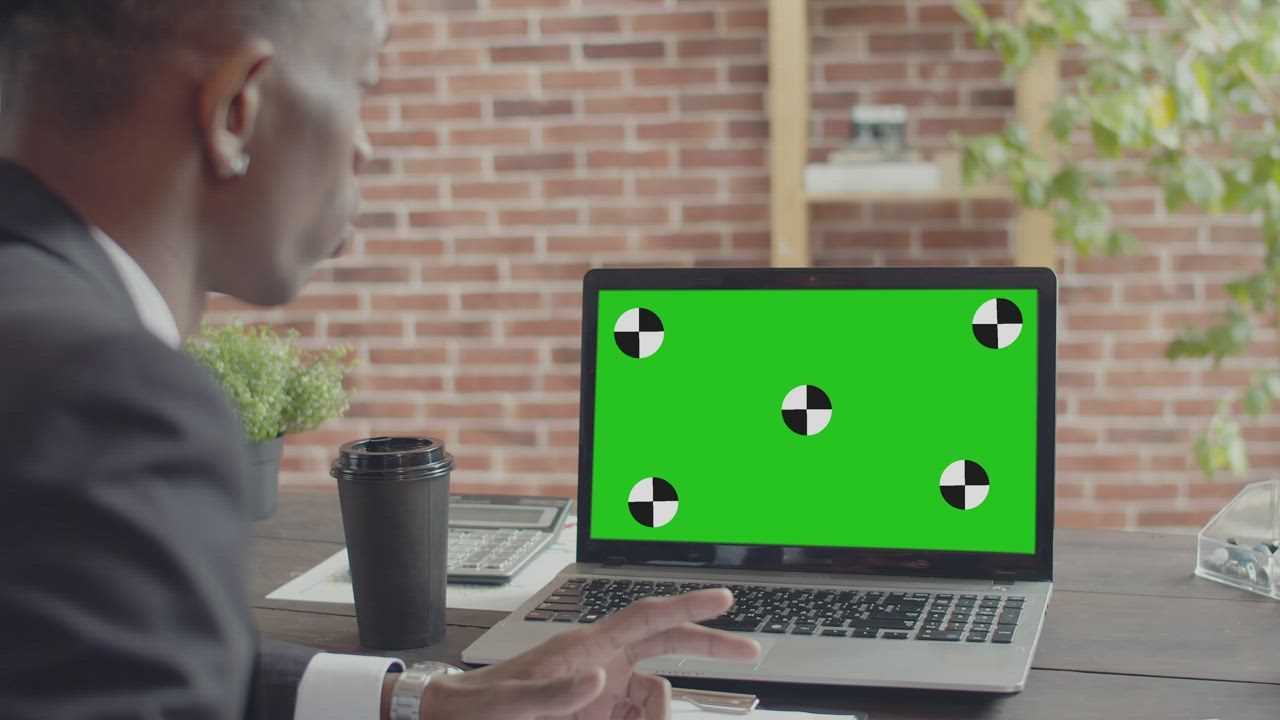 Man talking in front of a laptop green screen - Free Stock Video