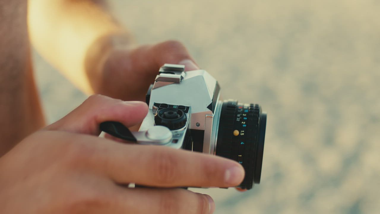 Hands manipulating a vintage photo camera - Free Stock Video