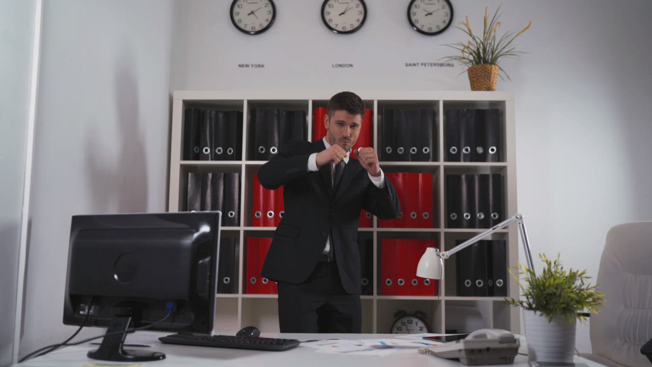 Businessman dancing in an office - Free Stock Video
