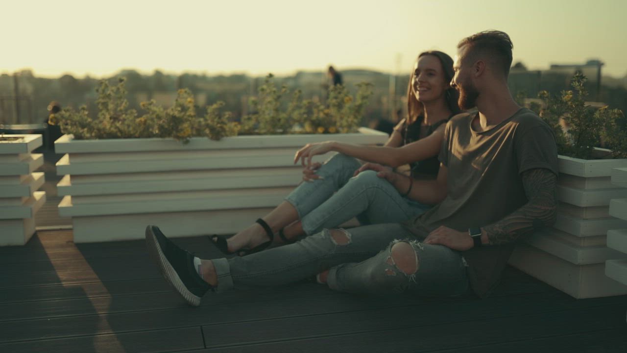 A perfect date on a rooftop during sunset - Free Stock Video
