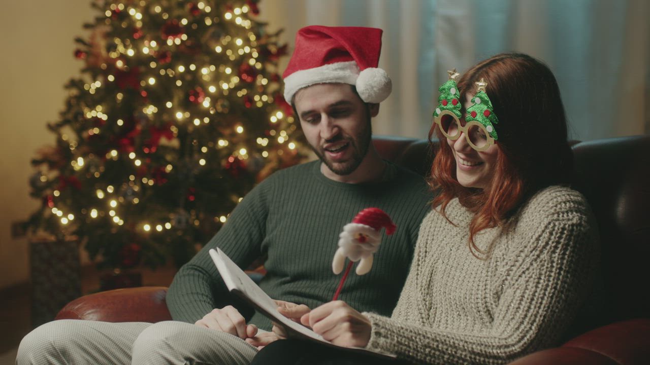 Couple writing a wish letter to Santa with Christmas tree in the ...