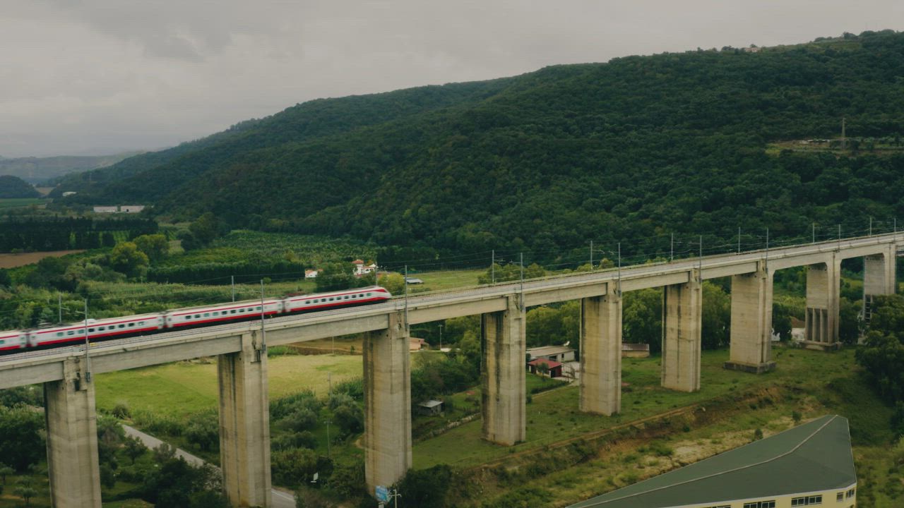Train traveling over a bridge in the middle of the mountains - Free ...