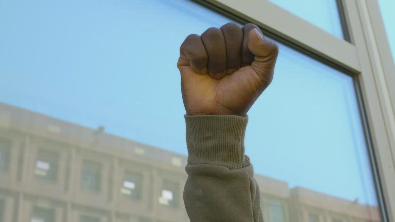 A fist in front of a glass windo - Free Stock Video