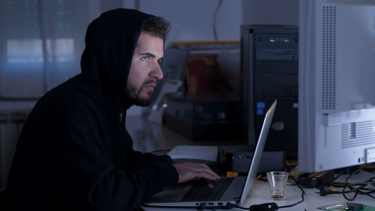 Man aggressively typing on his laptop in the dark - Free Stock Video