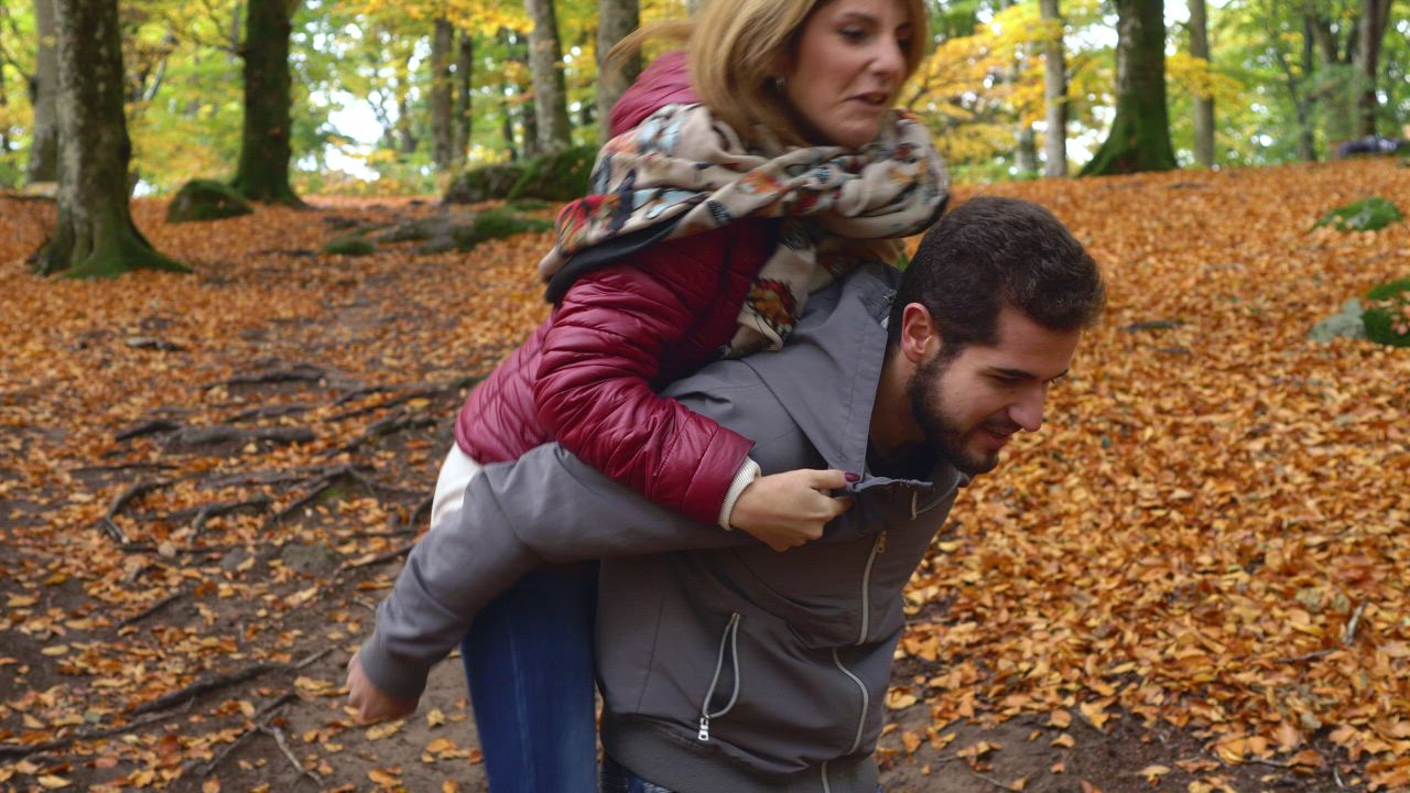 Woman enjoying a piggyback from her partner in the park - Free Stock Video