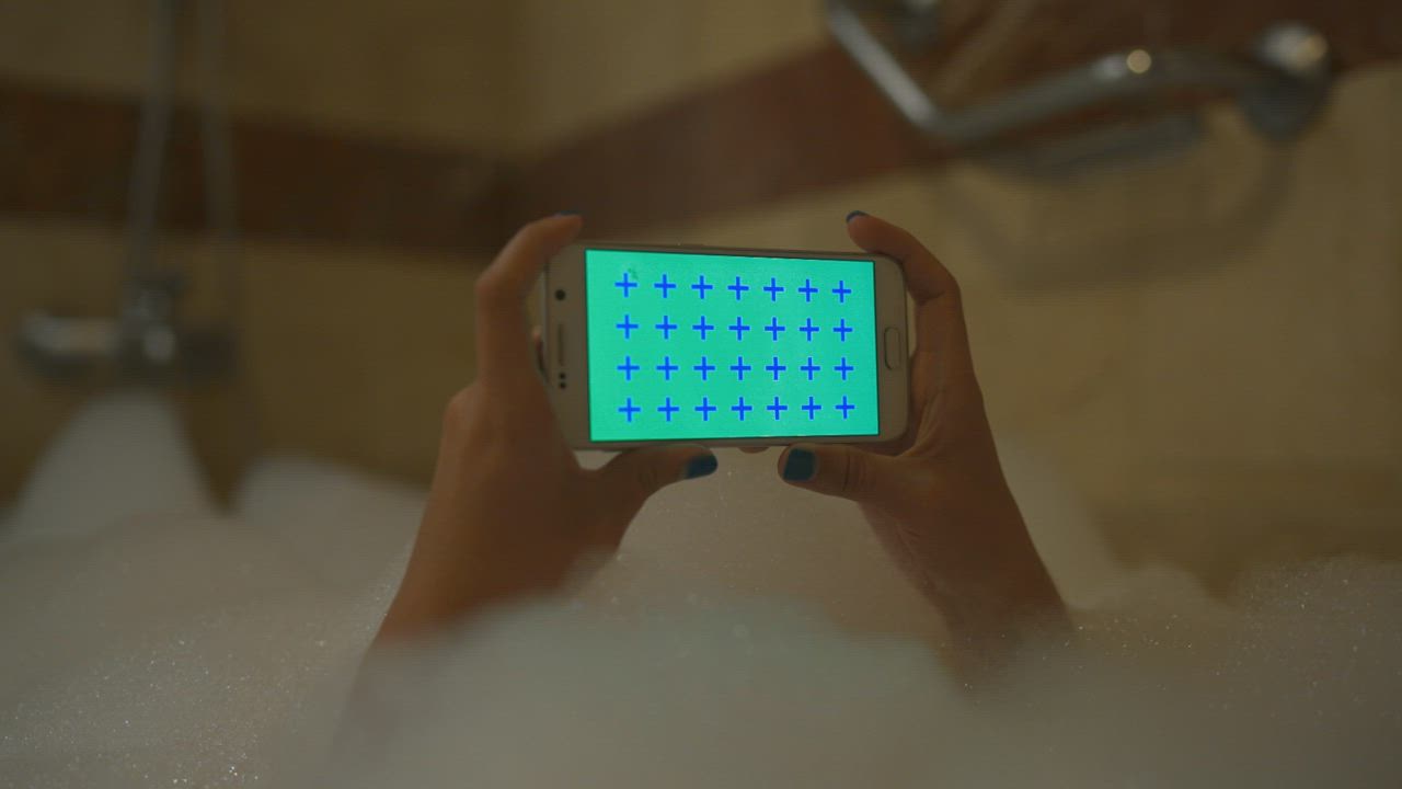 Person with his cell phone in a foam bath - Free Stock Video