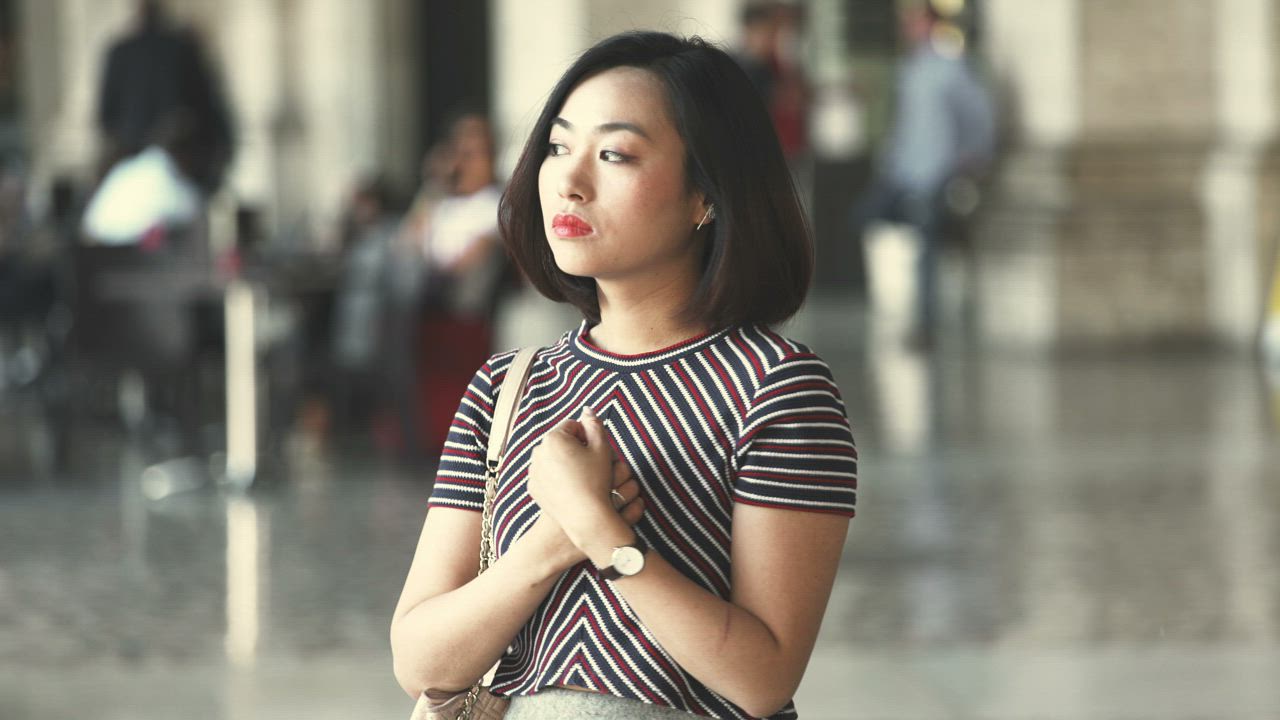 Young woman smiling shyly at the camera - Free Stock Video