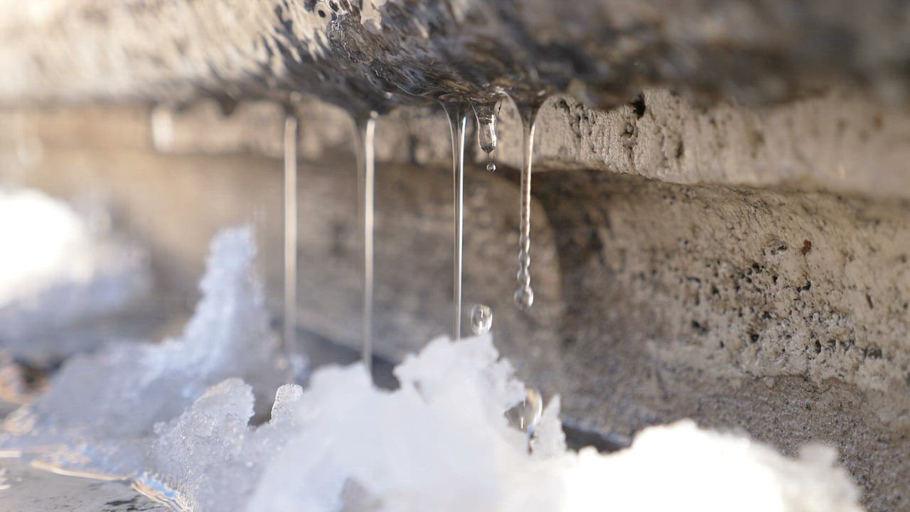 Close up of ice melting on concrete - Free Stock Video