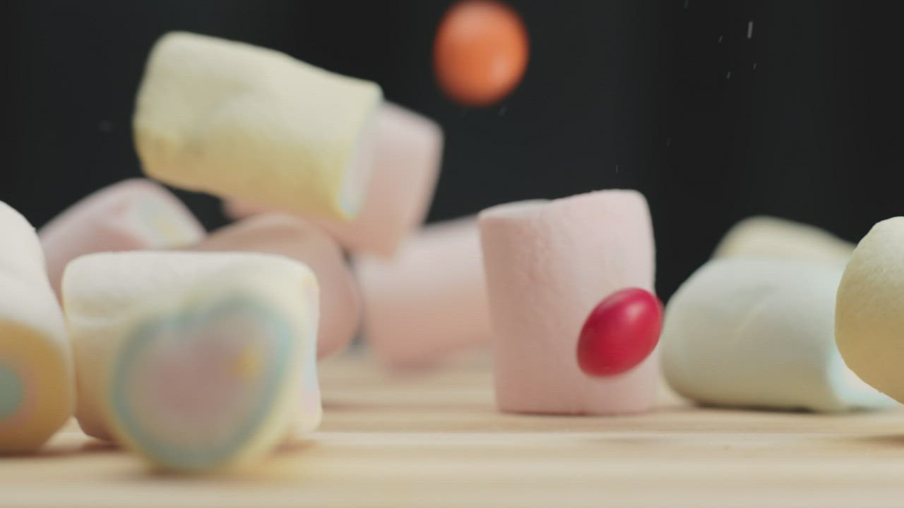 Marshmallows and candies falling down in slow motion - Free Stock Video