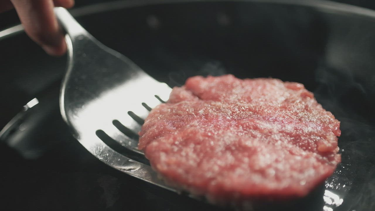 Chef cooking a piece of a hamburger meat - Free Stock Video