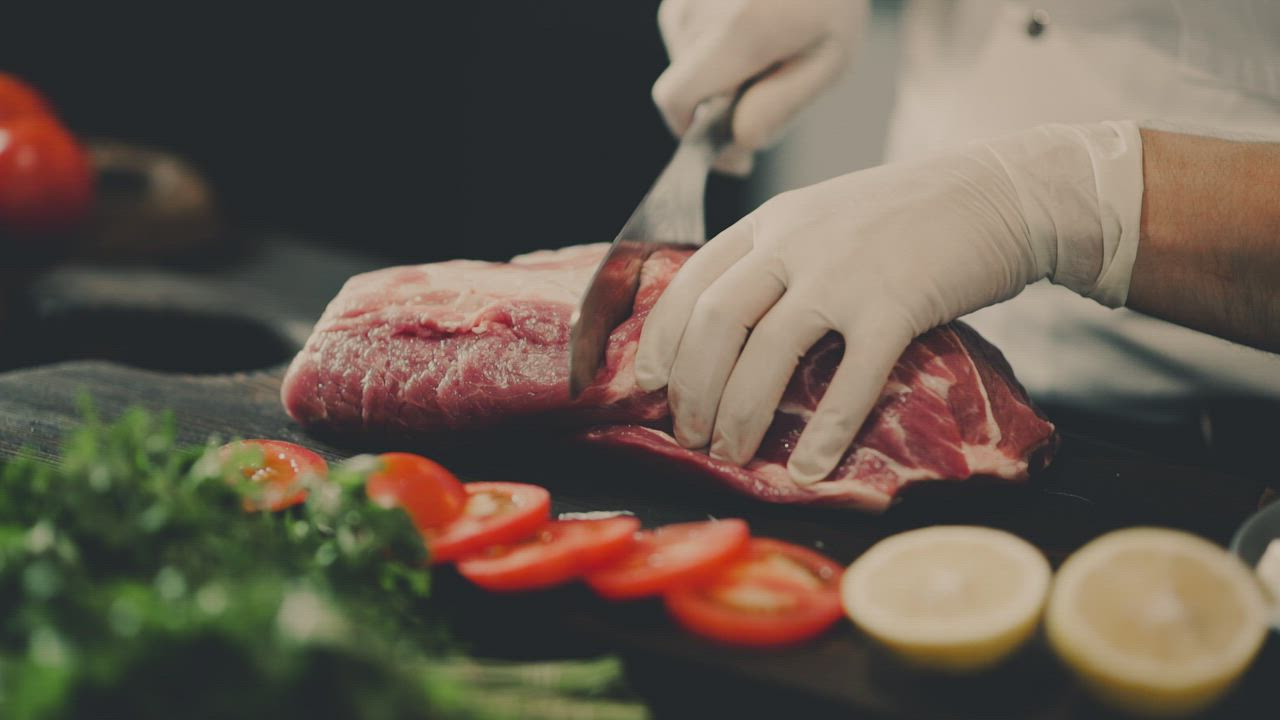 Cutting a large steak with a sharp knife - Free Stock Video