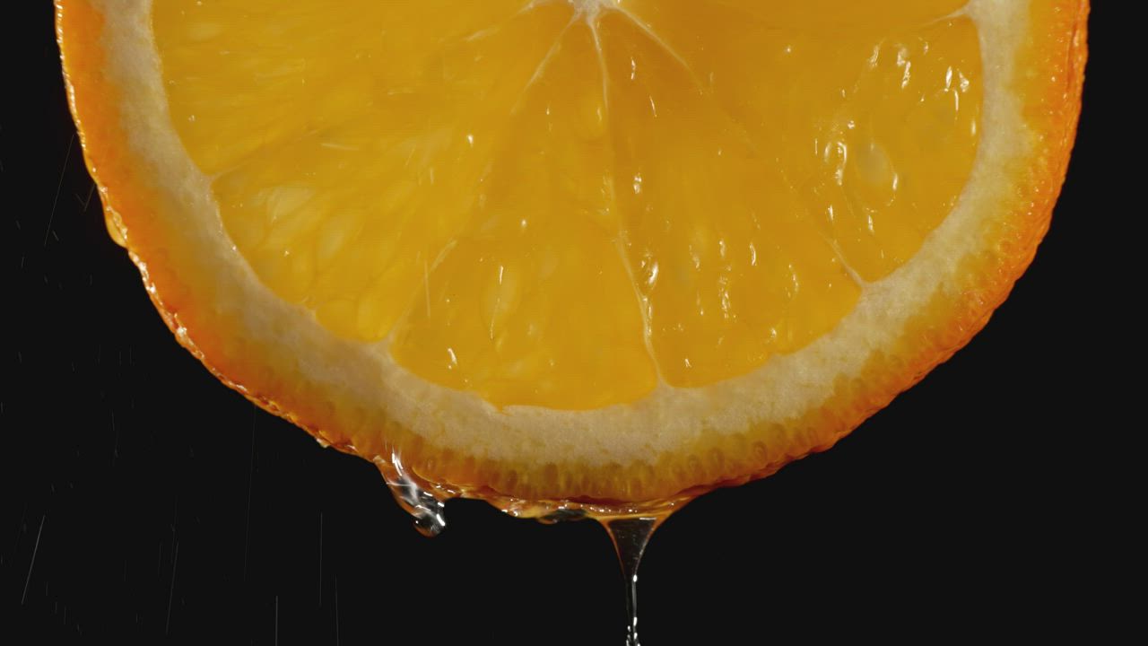 Drops of water dripping from an orange - Free Stock Video