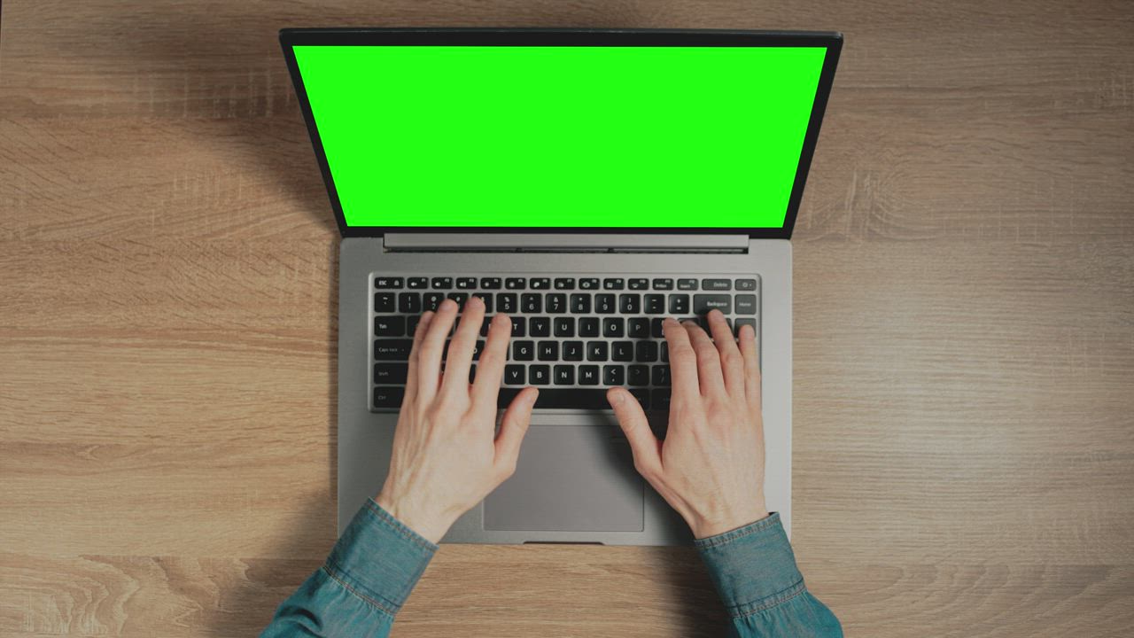 Hands typing with a green screen laptop - Free Stock Video