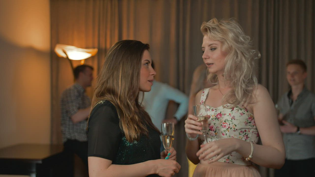 A couple of girls at a party gossiping - Free Stock Video