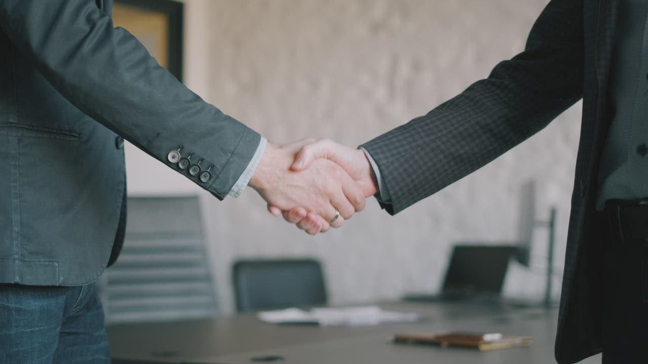 Close up of a handshake between two colleagues - Free Stock Video