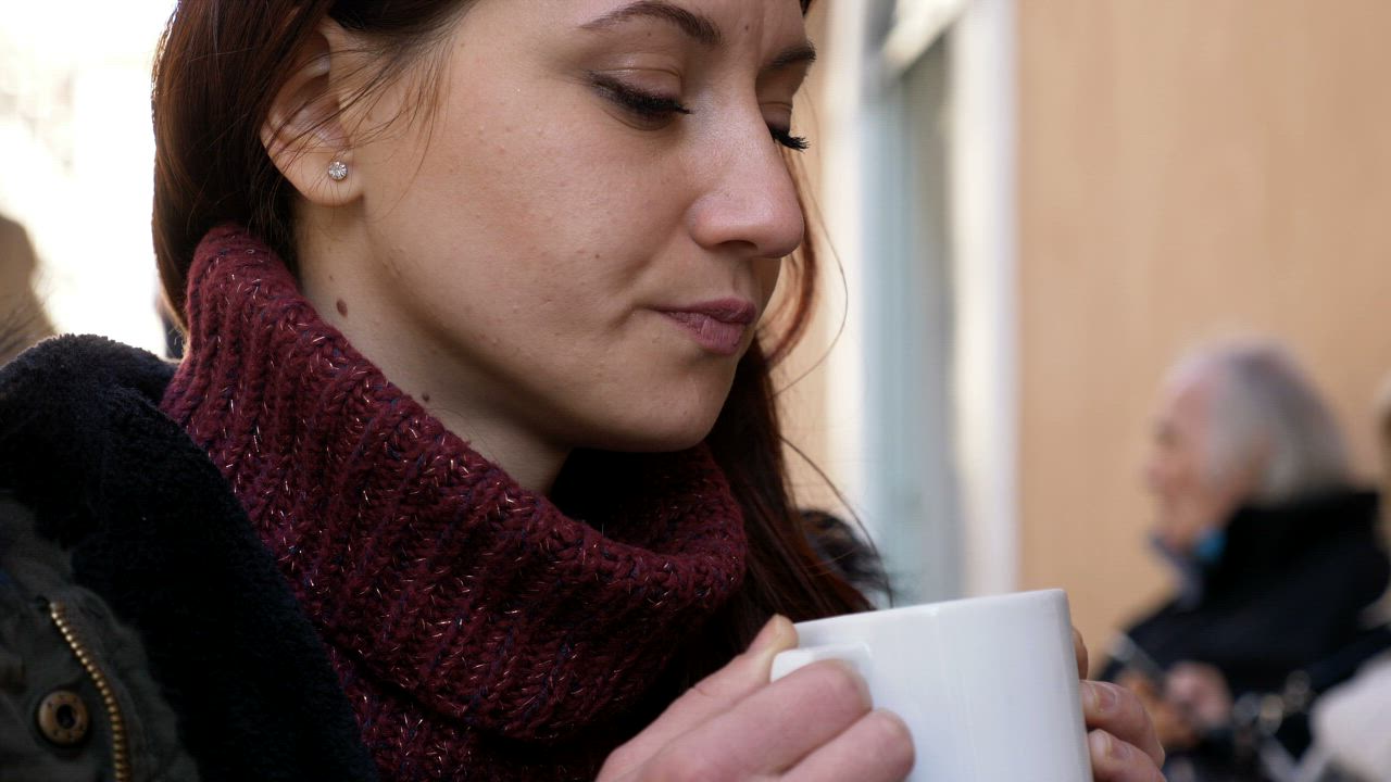 Woman sips on a cup of coffee before looking at the camera - Free Stock ...