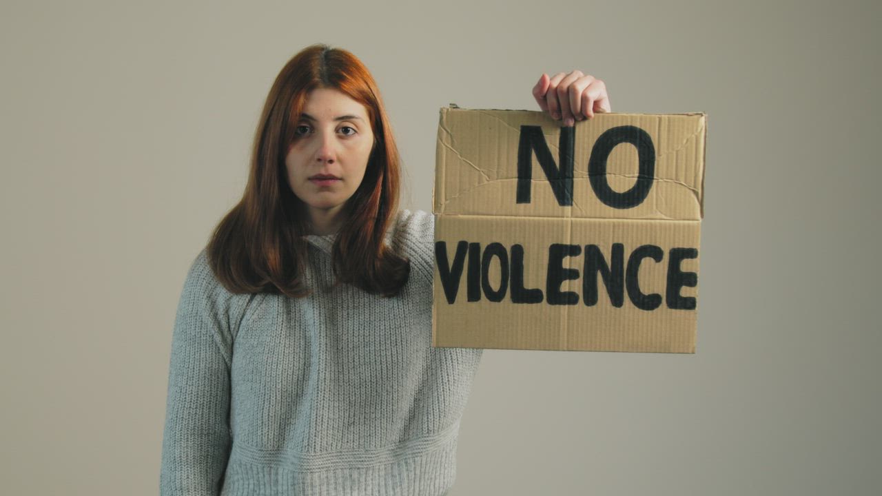 Girl holding a No Violence sign - Free Stock Video