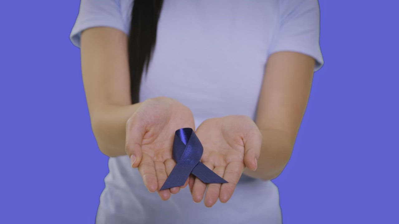 Woman with a leiomyosarcoma ribbon in her hands - Free Stock Video