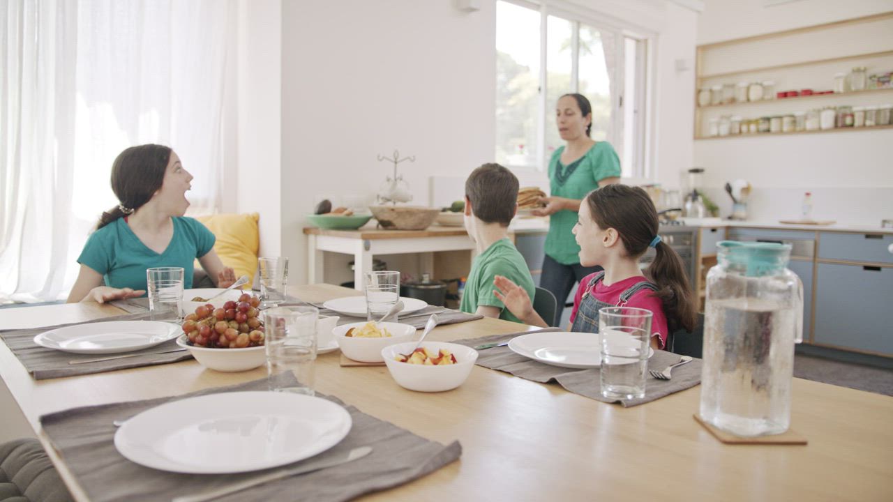 Mom serving a plate full of pancakes for breakfast - Free Stock Video