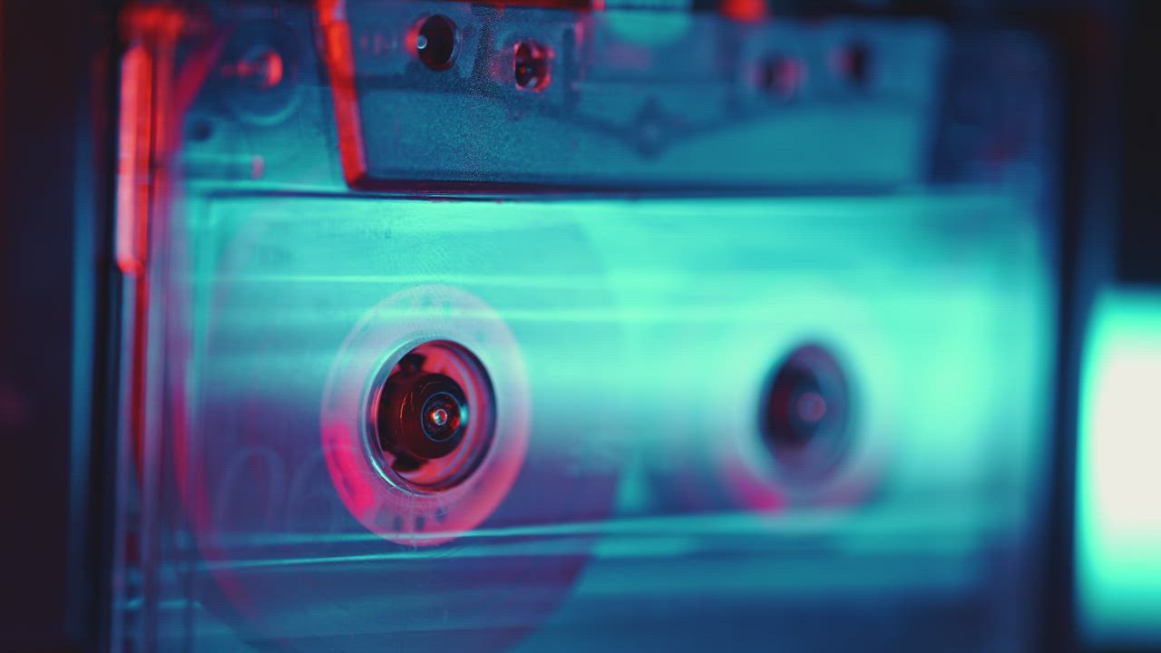 Close up of a cassette tape with neon lights - Free Stock Video