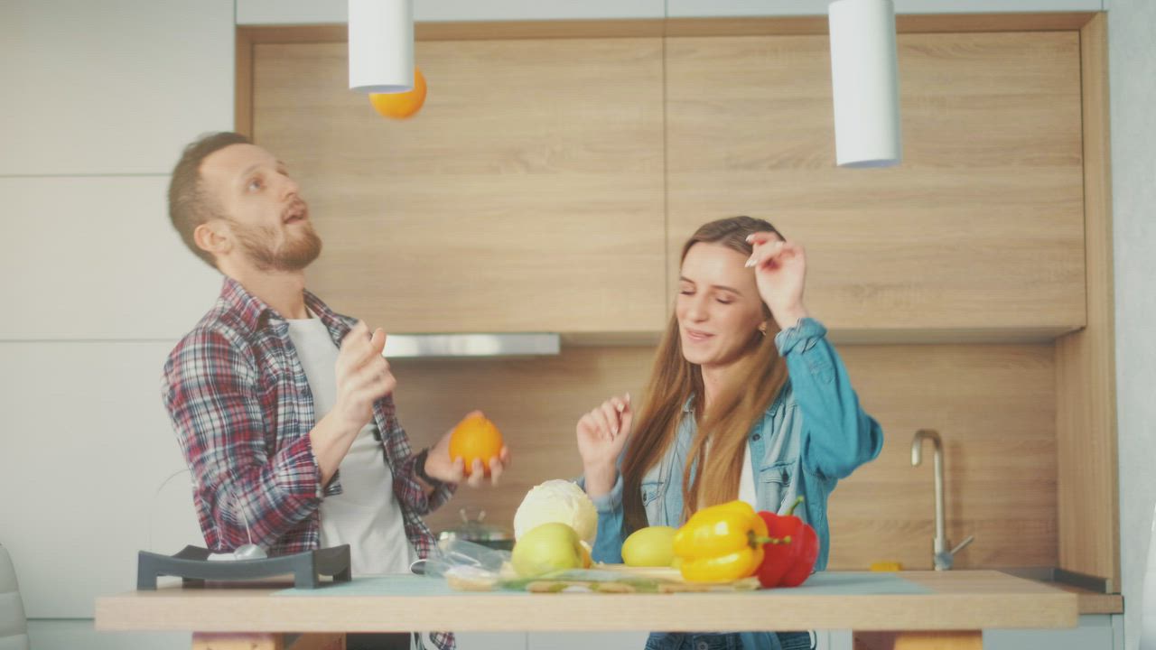 Hilarious couple having fun in the kitchen - Free Stock Video
