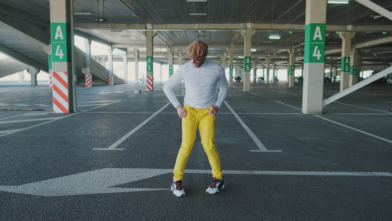 Hilarious dancing man in a parking - Free Stock Video