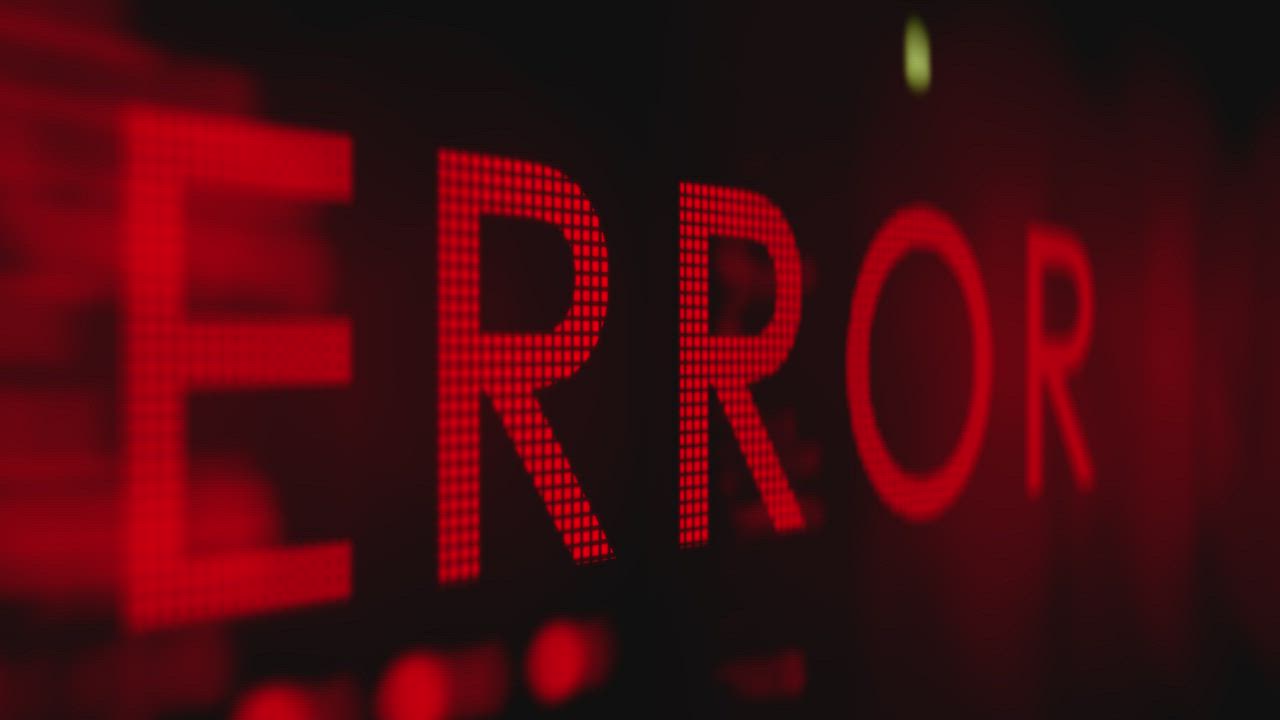 Pixelated red error message on a laptop screen - Free Stock Video