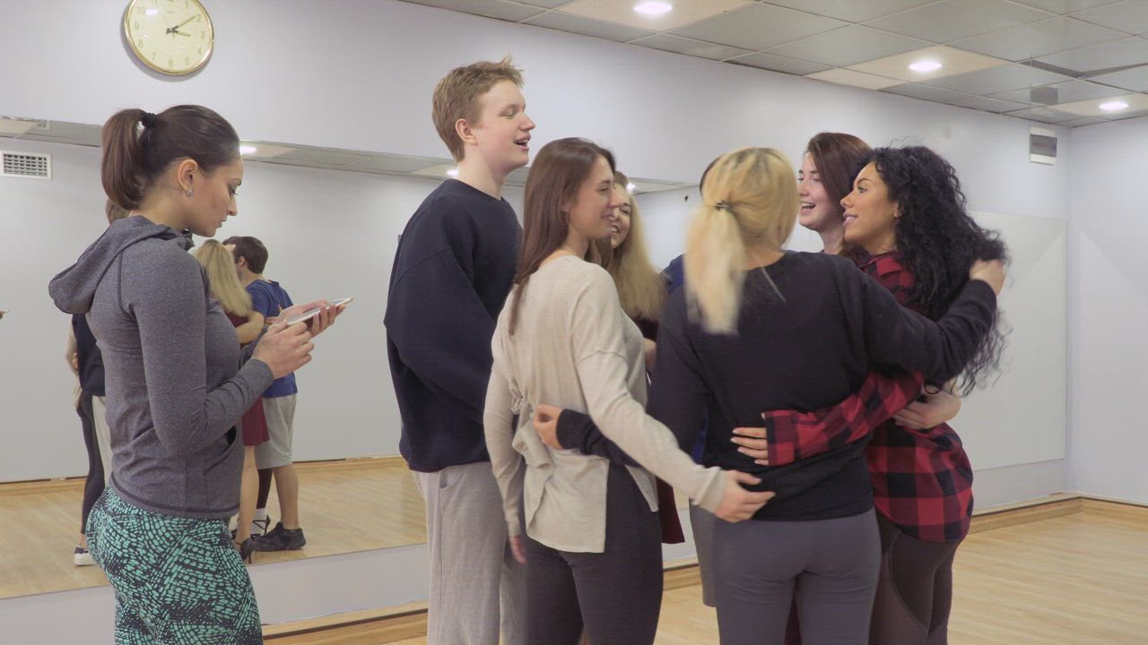 Cheerful young people giving each other a group hug - Free Stock Video