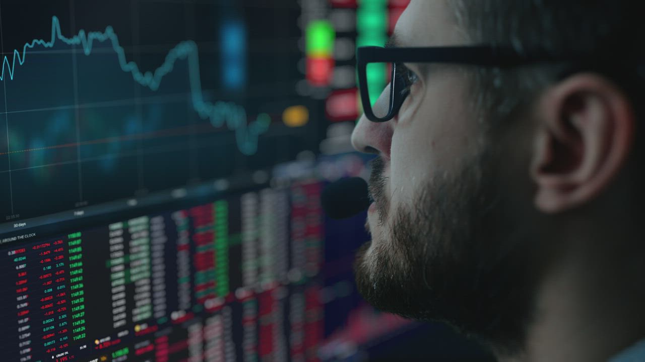 Man analyzing the stock market in real time - Free Stock Video