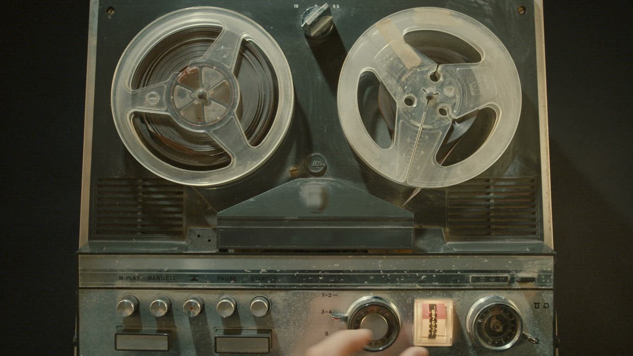 Hand turning on a vintage tape recorder - Free Stock Video