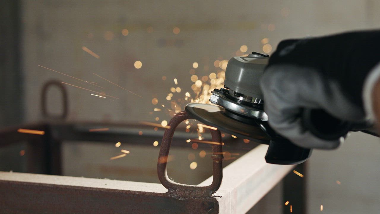 Worker using a metal grinder at a workshop - Free Stock Video
