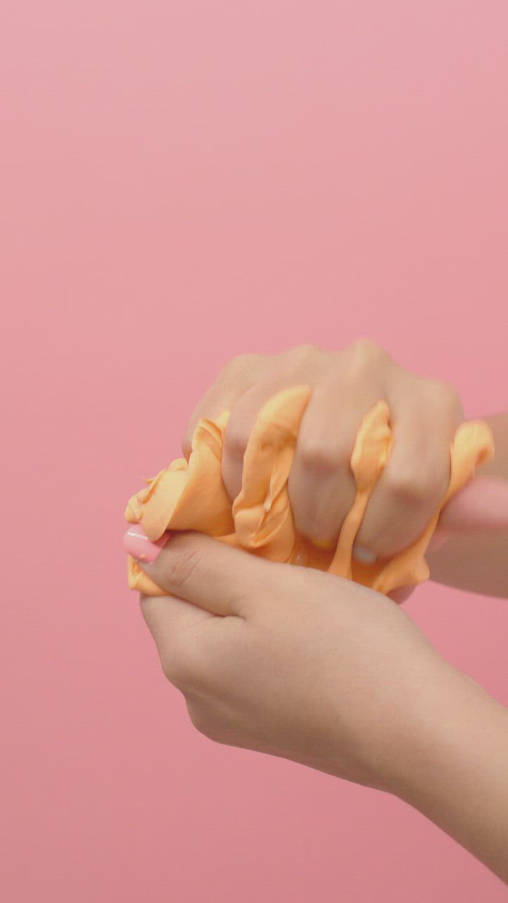 Woman playing, kneading orange modeling clay - Free Stock Video