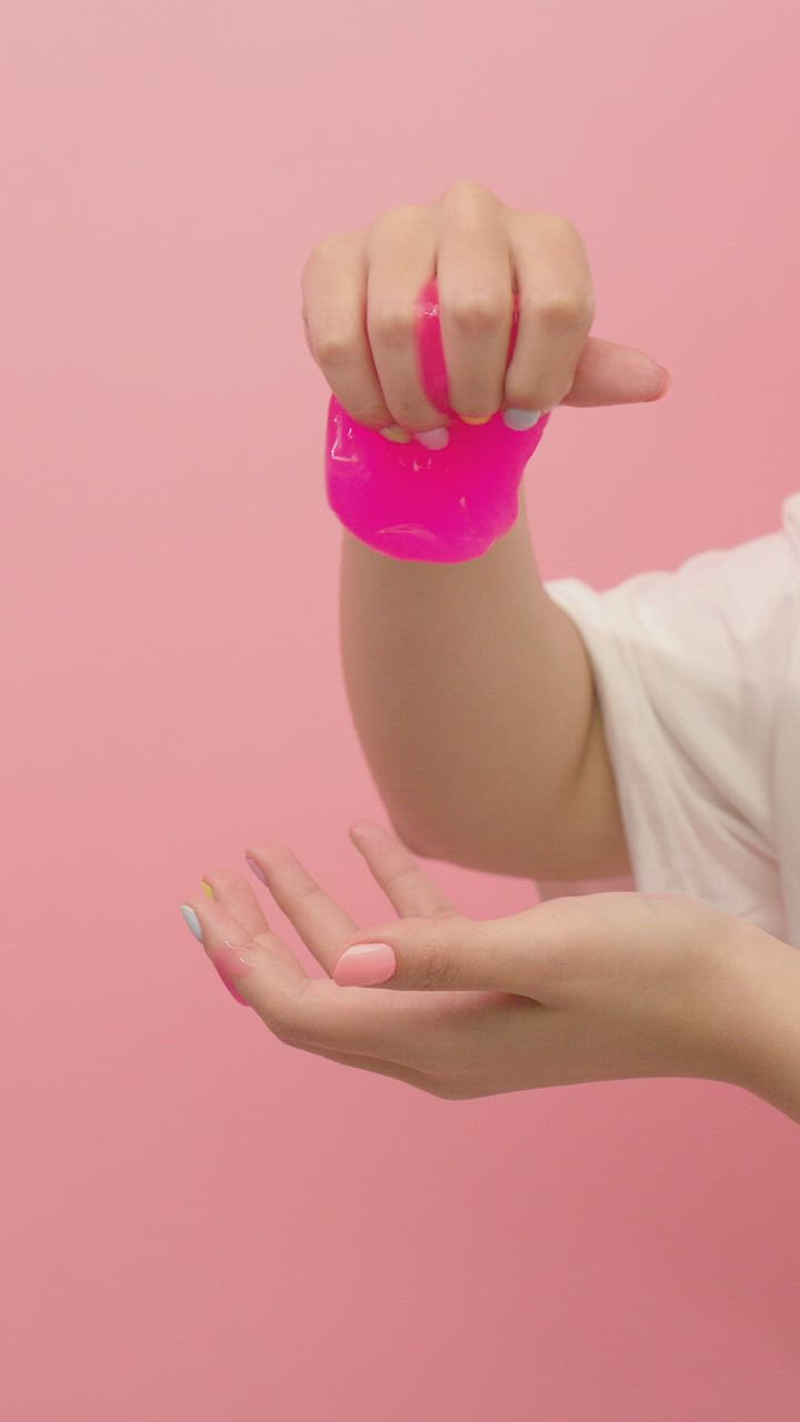 Young woman having fun with pink slime - Free Stock Video
