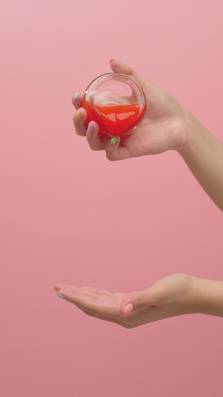 Woman playing with slippery red slime with a bowl - Free Stock Video