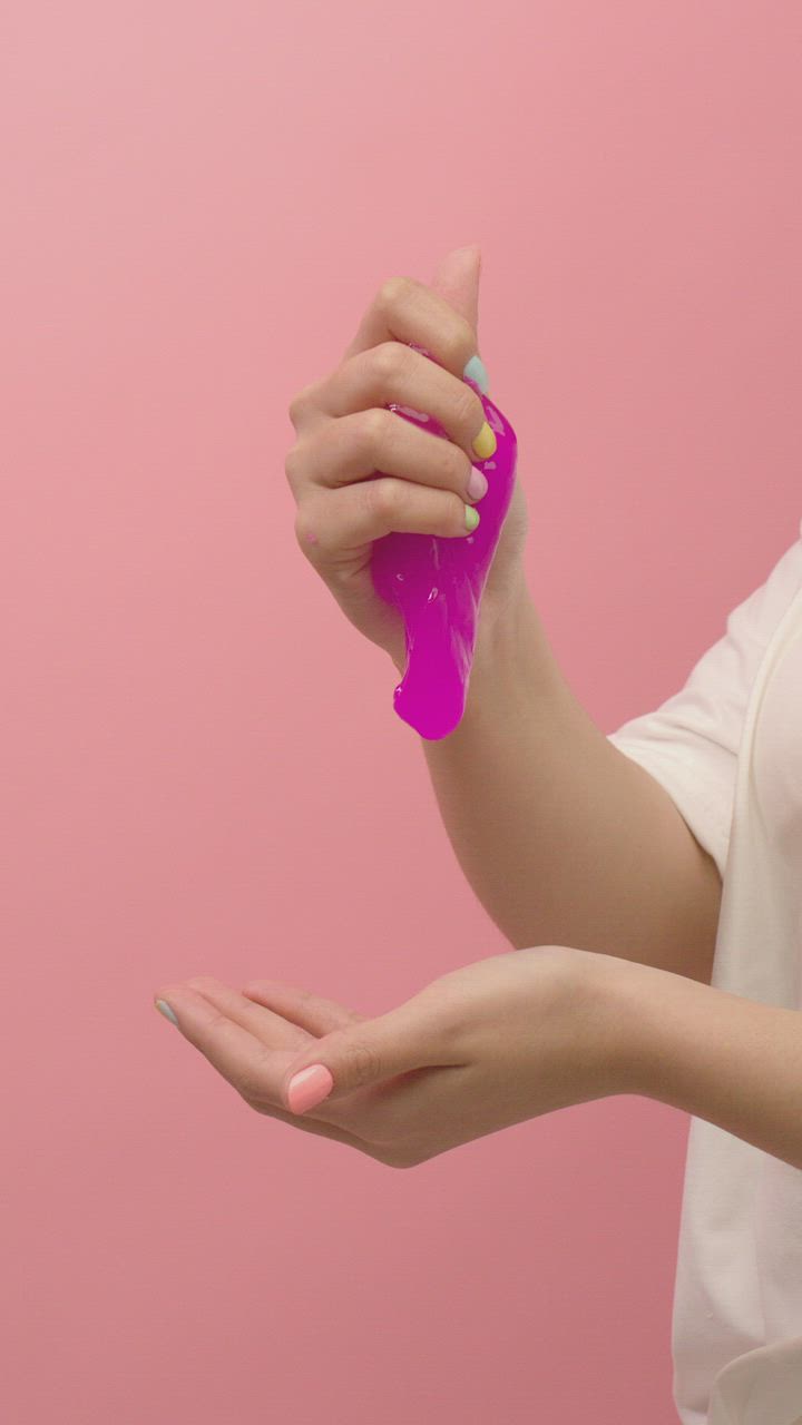 Hands of a woman playing with purple slime - Free Stock Video