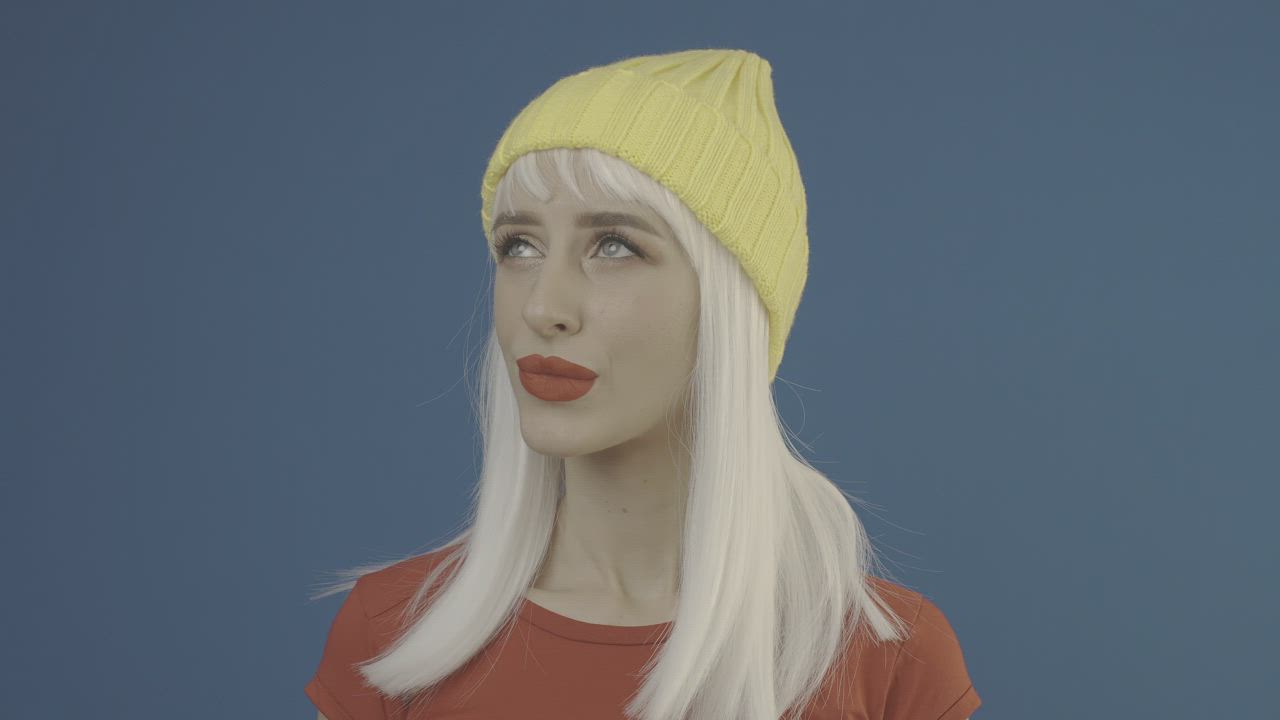 Girl overthinking with a blue background - Free Stock Video