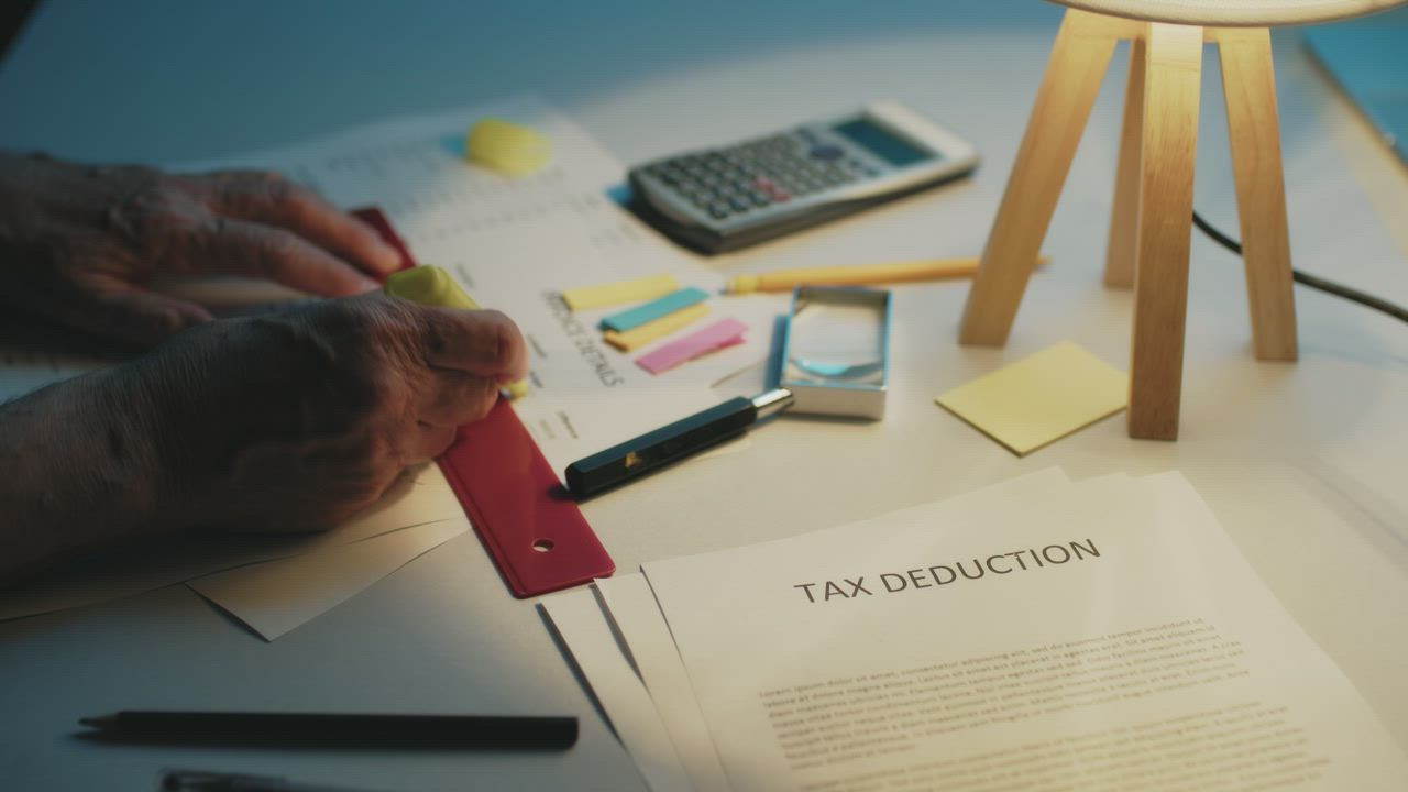 Man makes accounts of his finances and prepares his tax deduction ...