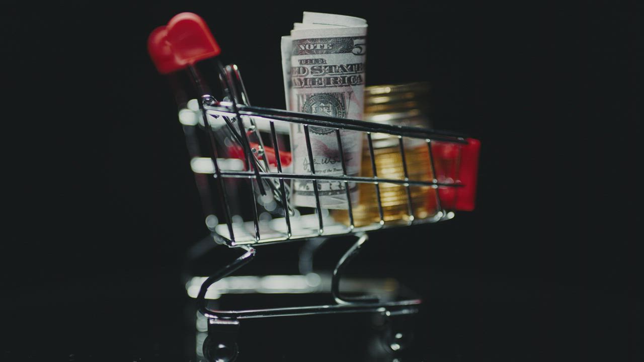 Close up of rotating coins and bills - Free Stock Video