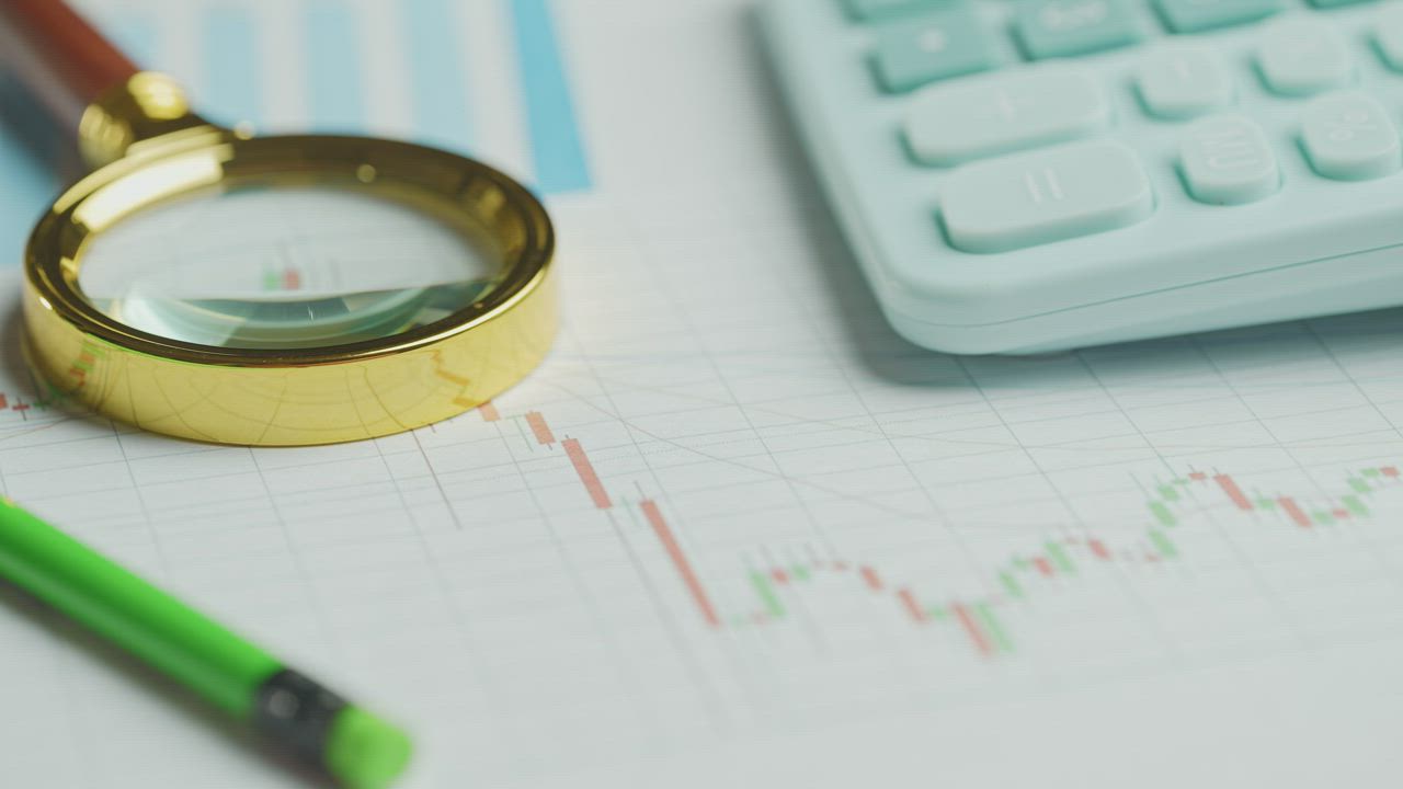 Documents with magnifying glass on a table - Free Stock Video