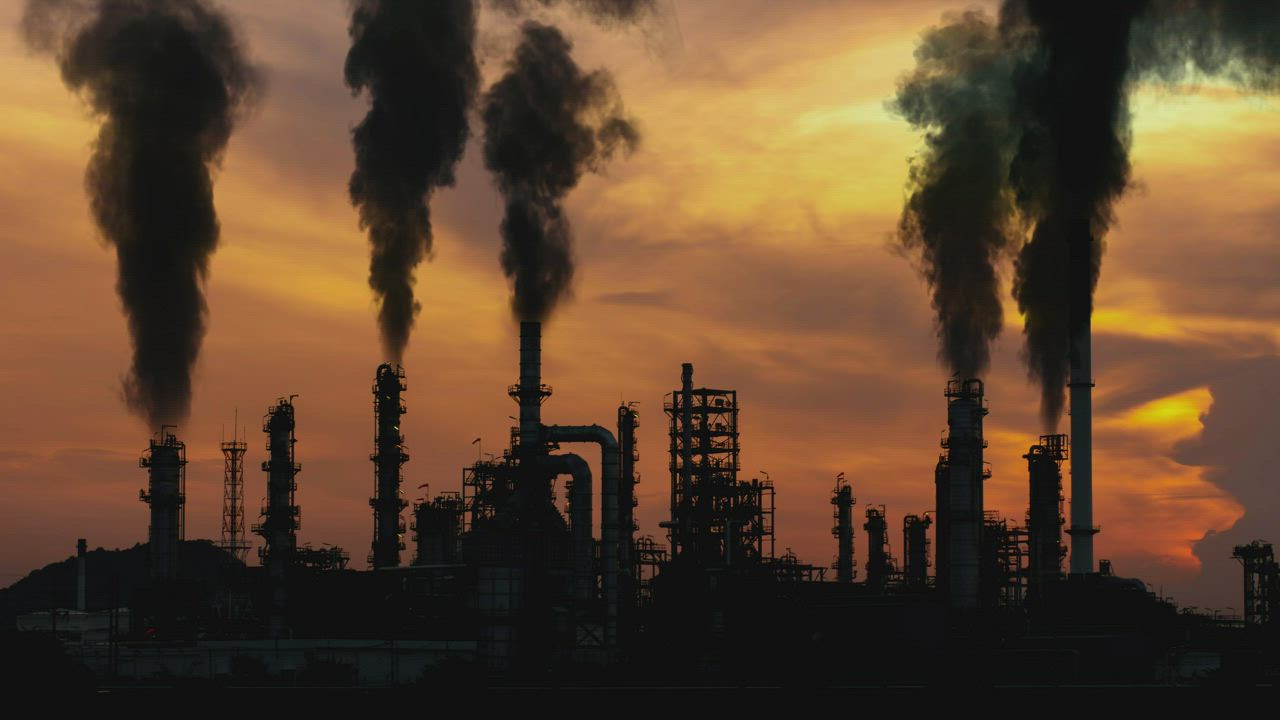 Smoking factory chimneys producing a lot of emissions - Free Stock Video