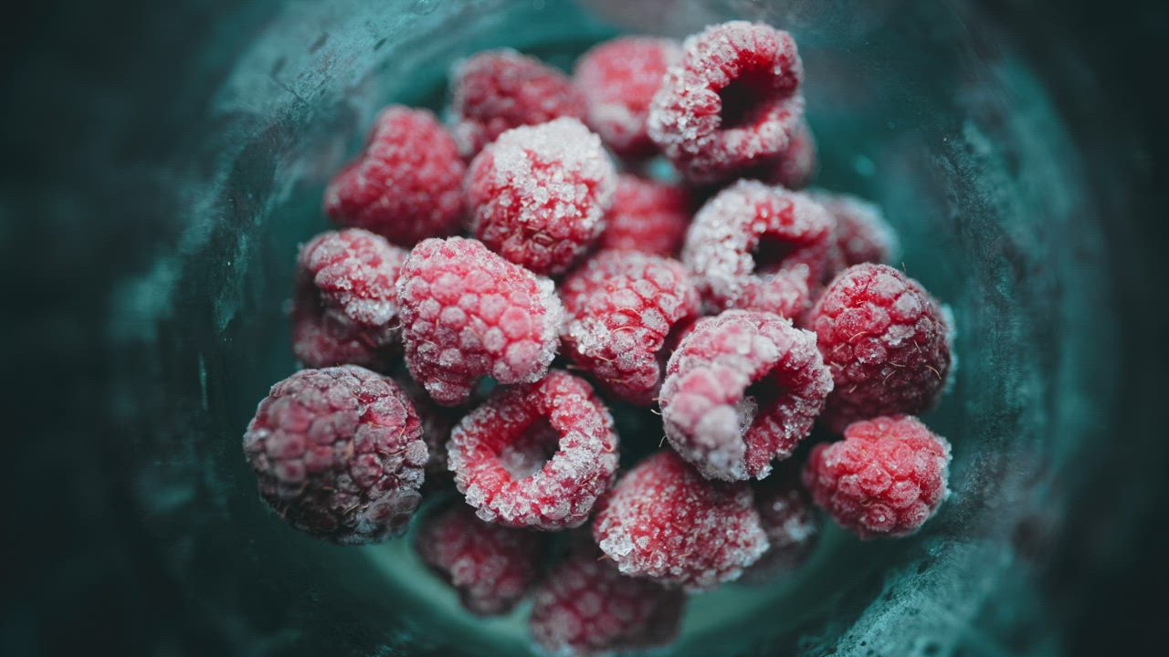 Frozen raspberries inside a big glass - Free Stock Video